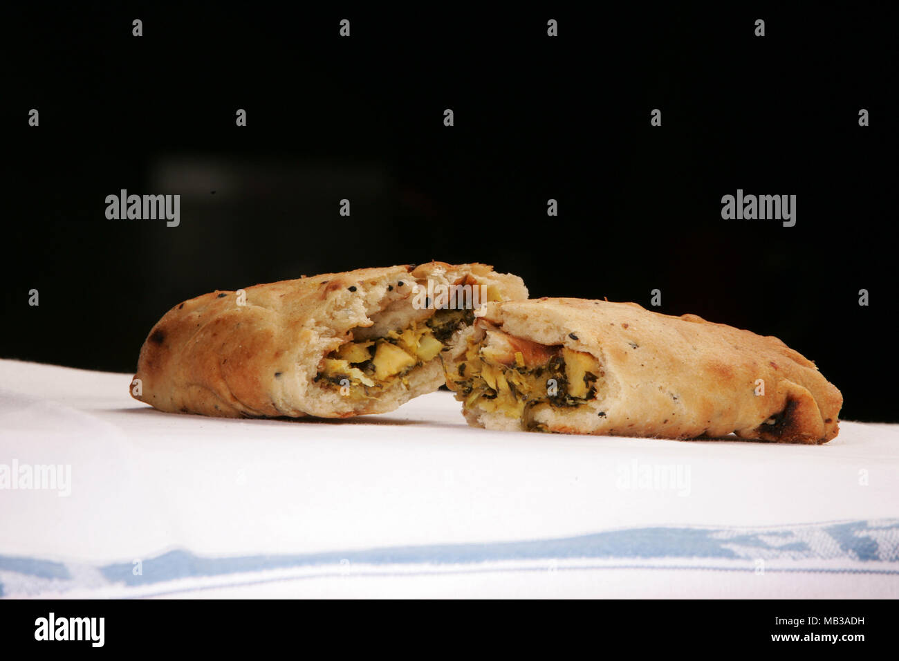 A pasty food snack opened in half to see filling Stock Photo - Alamy