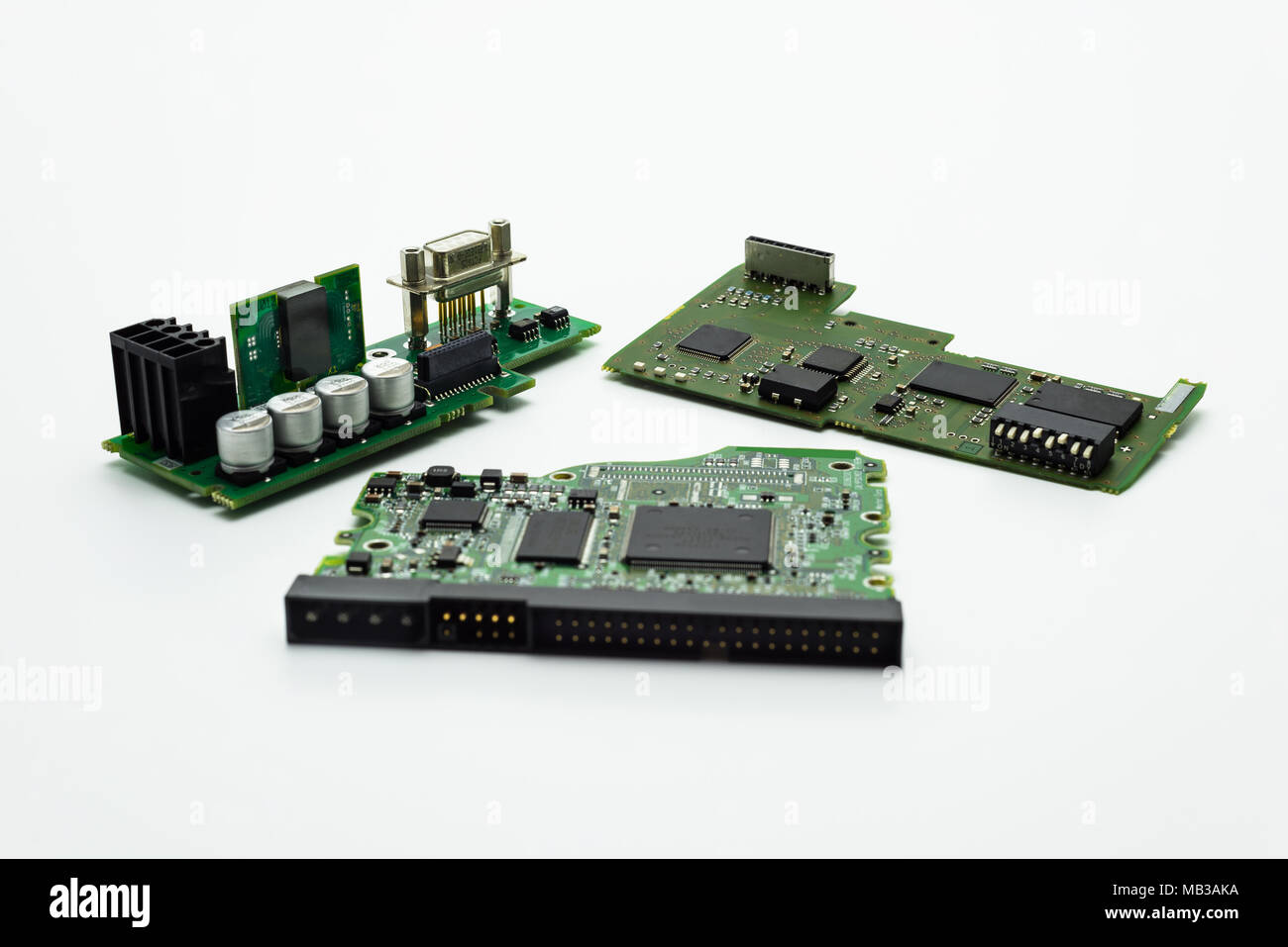 Three integrated circuits with visible microprocessors, capacitors and ...