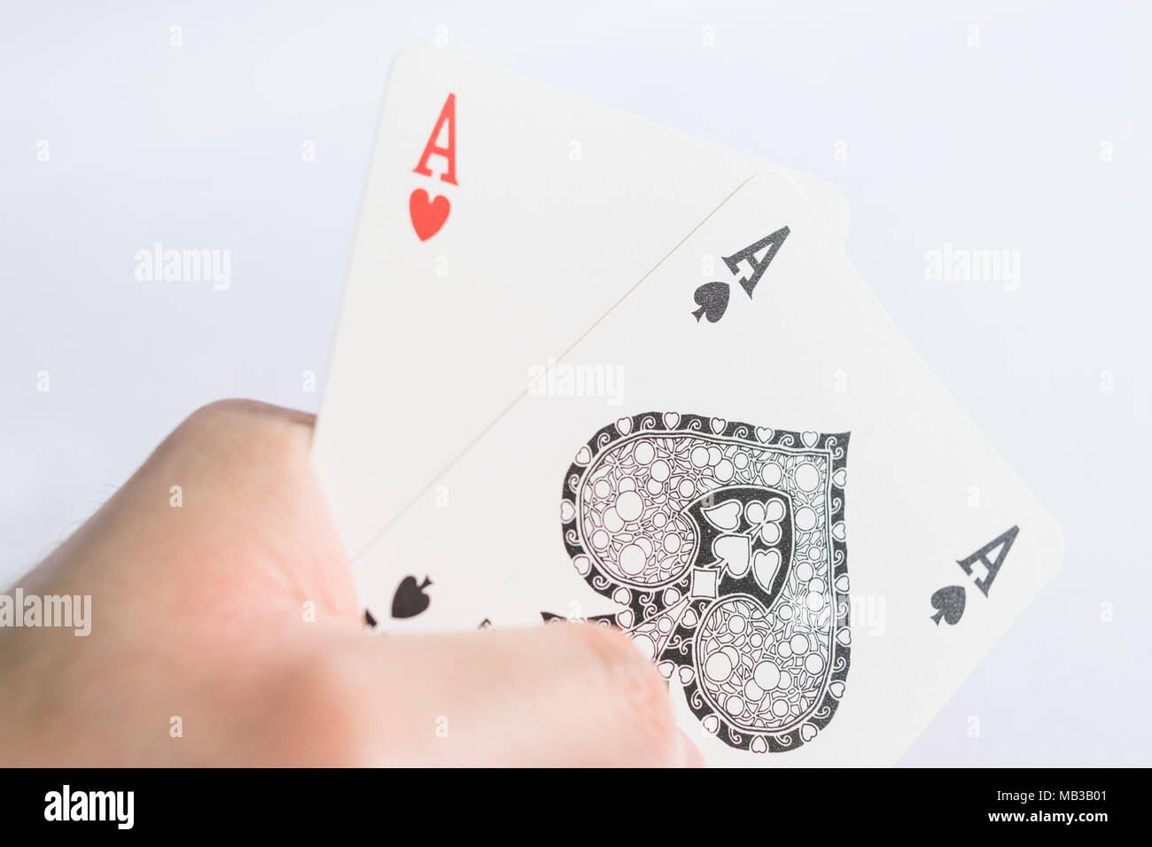 Heart and spades aces of cards in the hand on white background Stock ...
