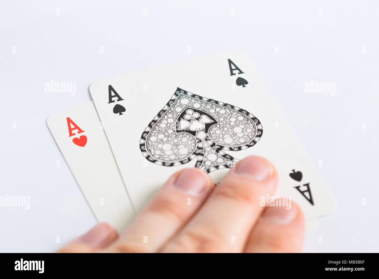 Heart and spades aces of cards in the hand on white background Stock ...