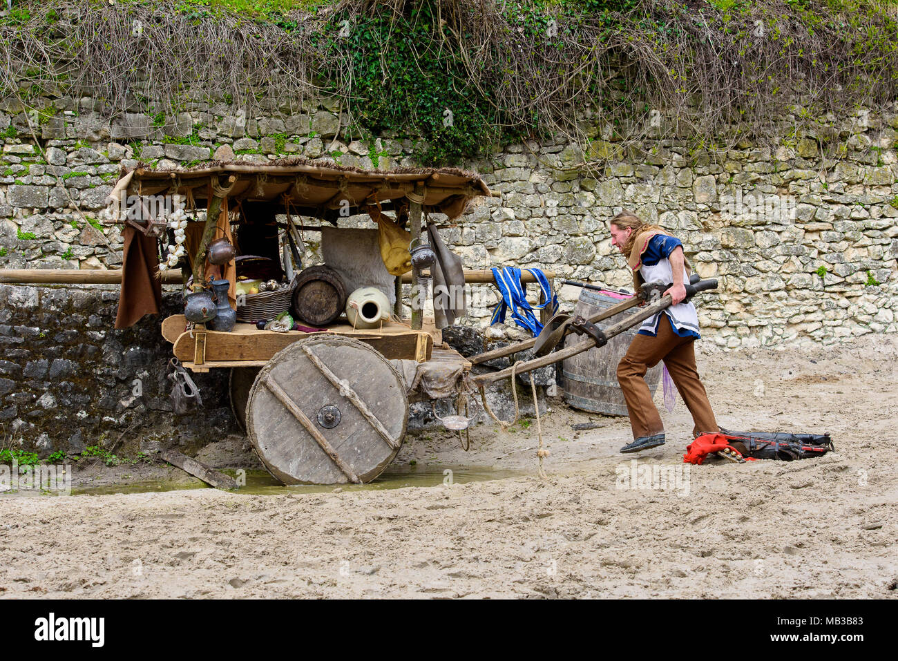 PROVINS, FRANCE - MARCH 31, 2018: Unidentified man carries a carriage ...