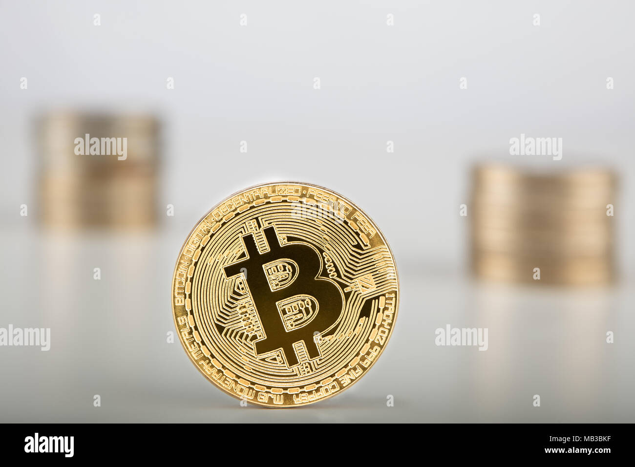 Stack of bitcoins with bitcoins background with a single coin facing ...