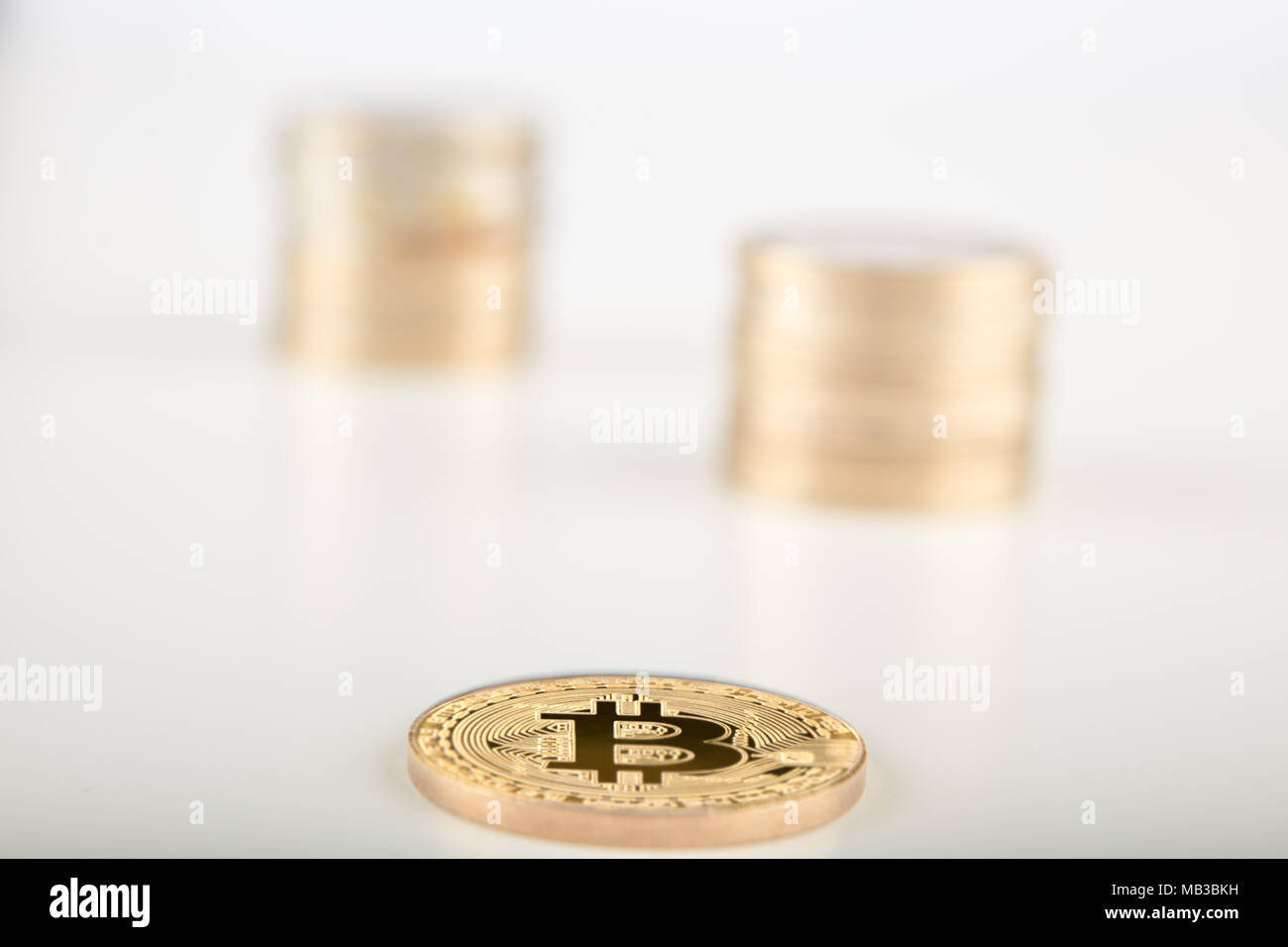 Stack of bitcoins with bitcoins background with a single coin facing ...