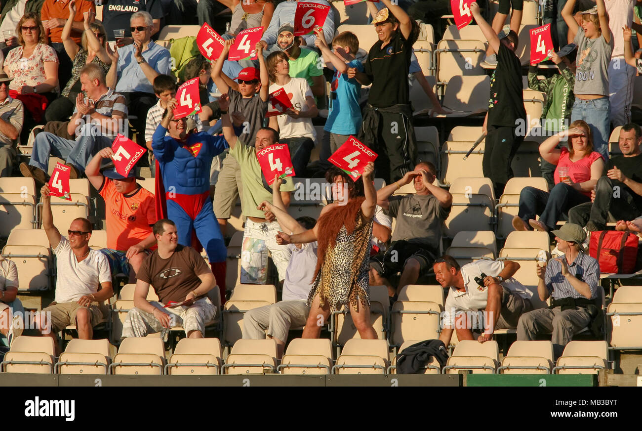 The crowd some dressed in fancy dress as Superman and a caveman cheer ...