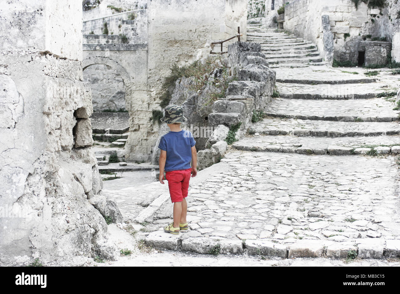 A child stops at a crossroads leading through the ancient and ...