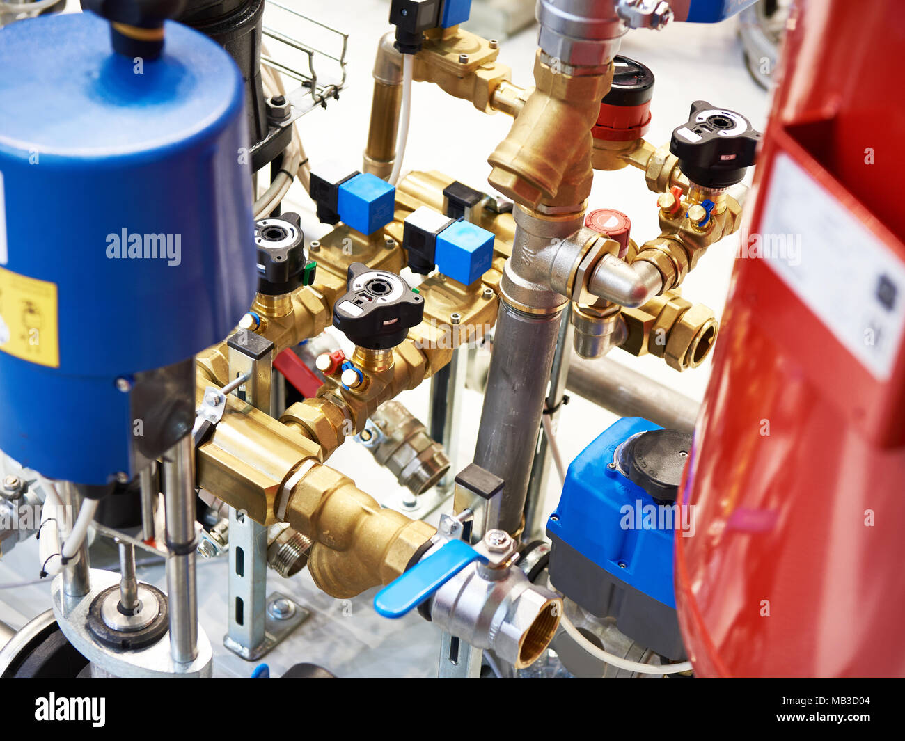 Industrial equipment with pipes, valves, tanks and cranes Stock Photo ...