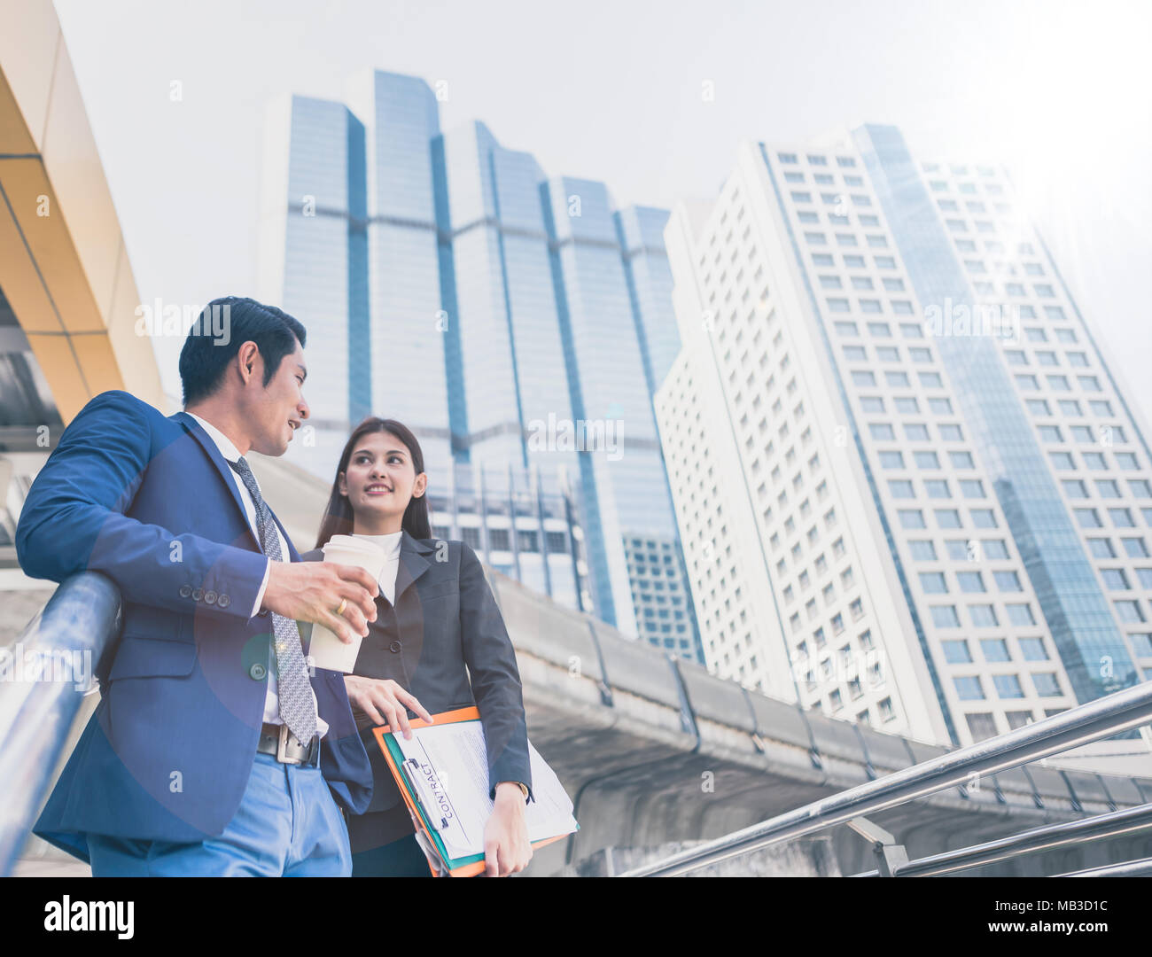 Happy Business colleagues talk outside office & talking to each other ...