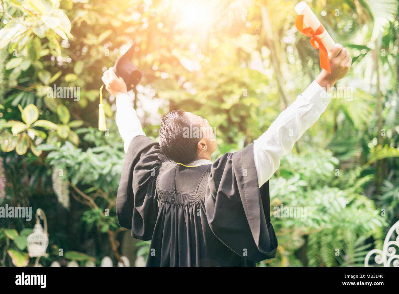 Graduate man students , back view of graduation day University ...