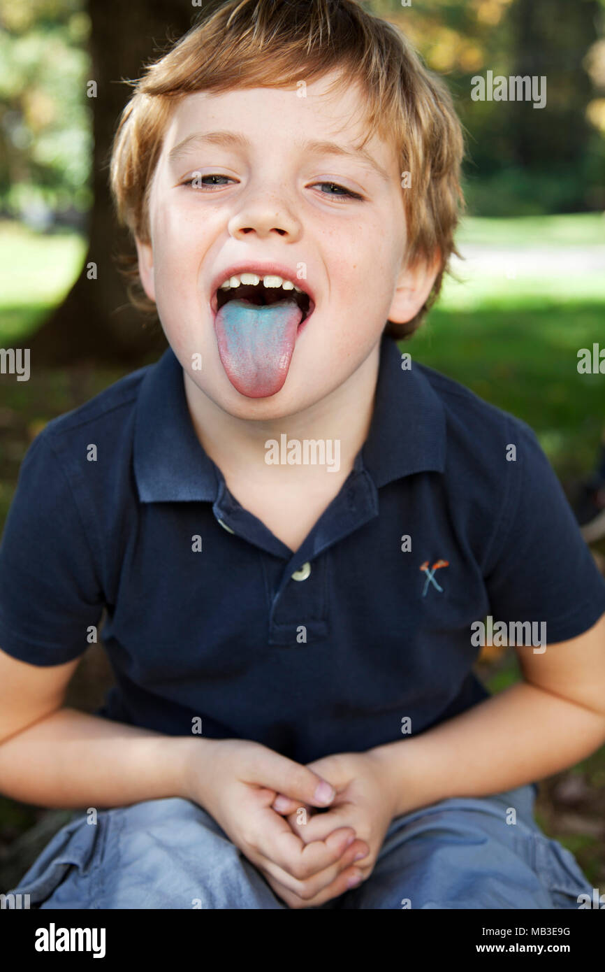 Young Boy Sticking Out Blue Tongue Stock Photo - Alamy