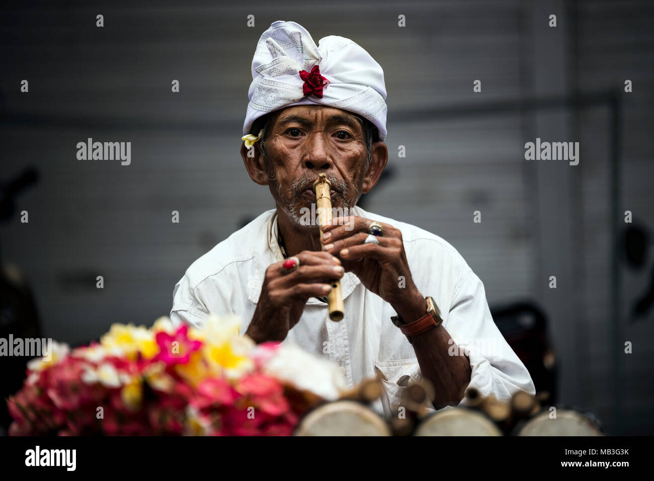 Bali, Indonesia - July 9, 2017. Balinese 50s male street musician ...
