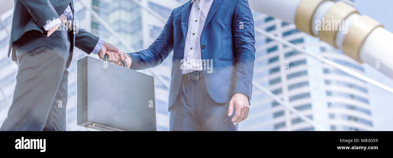 Businessman transfer deal, business black briefcase exchange urban city ...