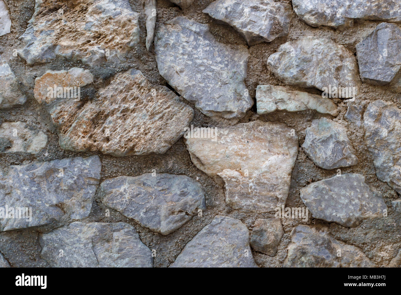 Natural stone wall texture, old streets of greece Stock Photo - Alamy