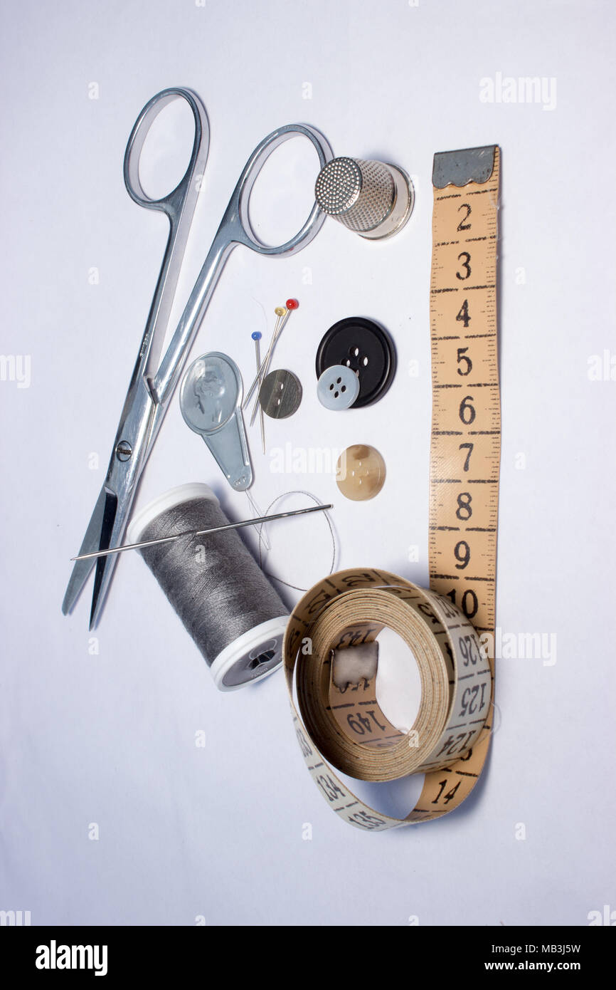 Sewing, thread coils, needles, needle threader, scissors, push pins ...