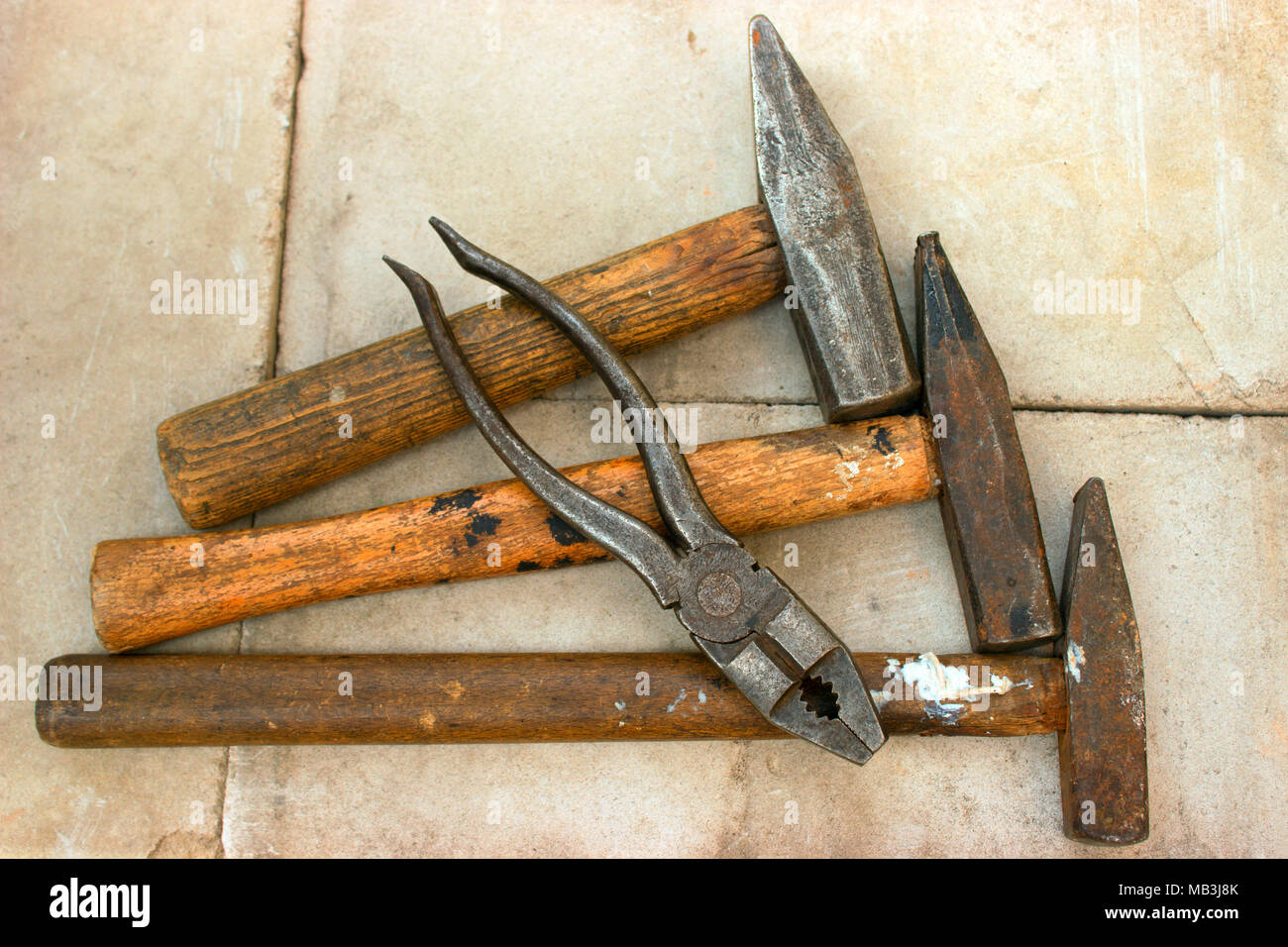 Old rusty tools must be replaced with new ones Stock Photo - Alamy