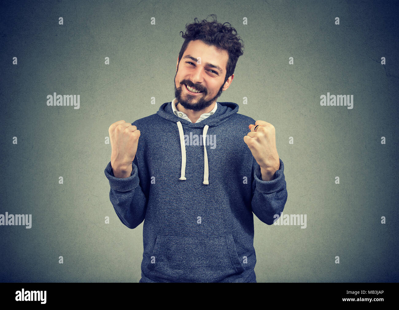 Happy successful student man winning, fists pumped celebrating success ...