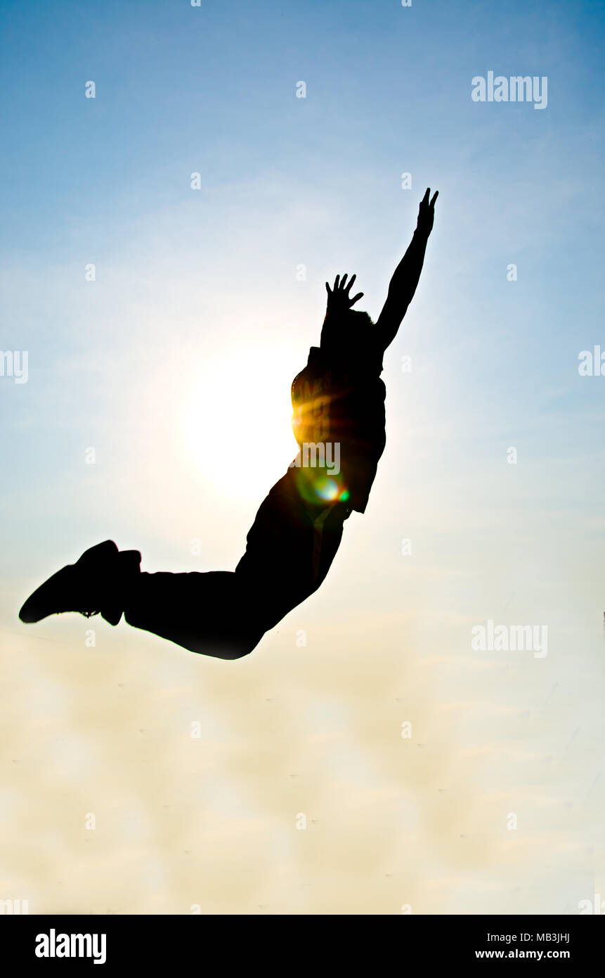 silhouette of man jumping for victory Stock Photo - Alamy