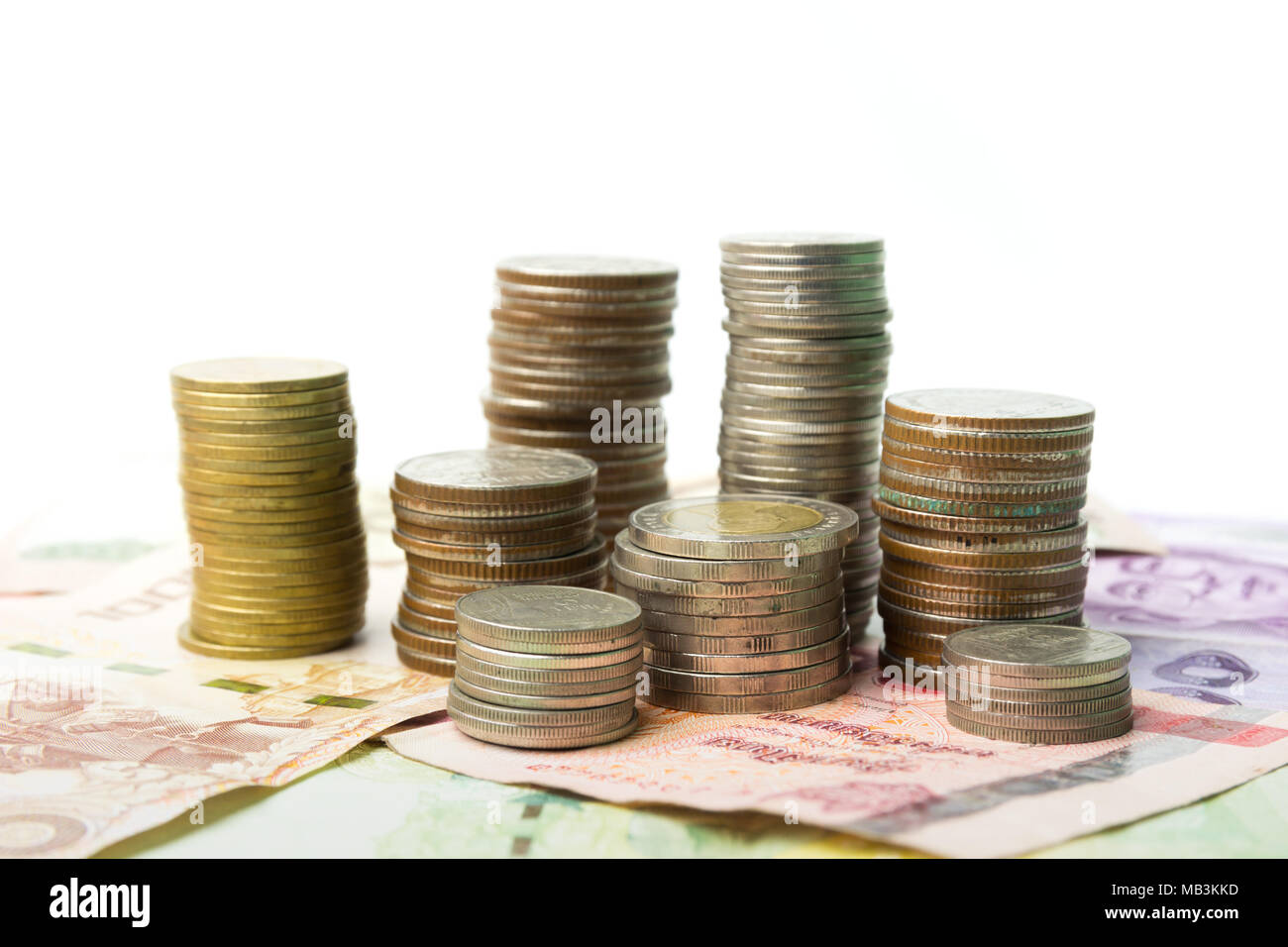 Baht coins on banknote money background Stock Photo - Alamy