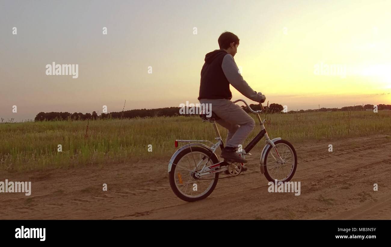 Boy teenager riding a bicycle. Boy teenager riding a bicycle goes to ...