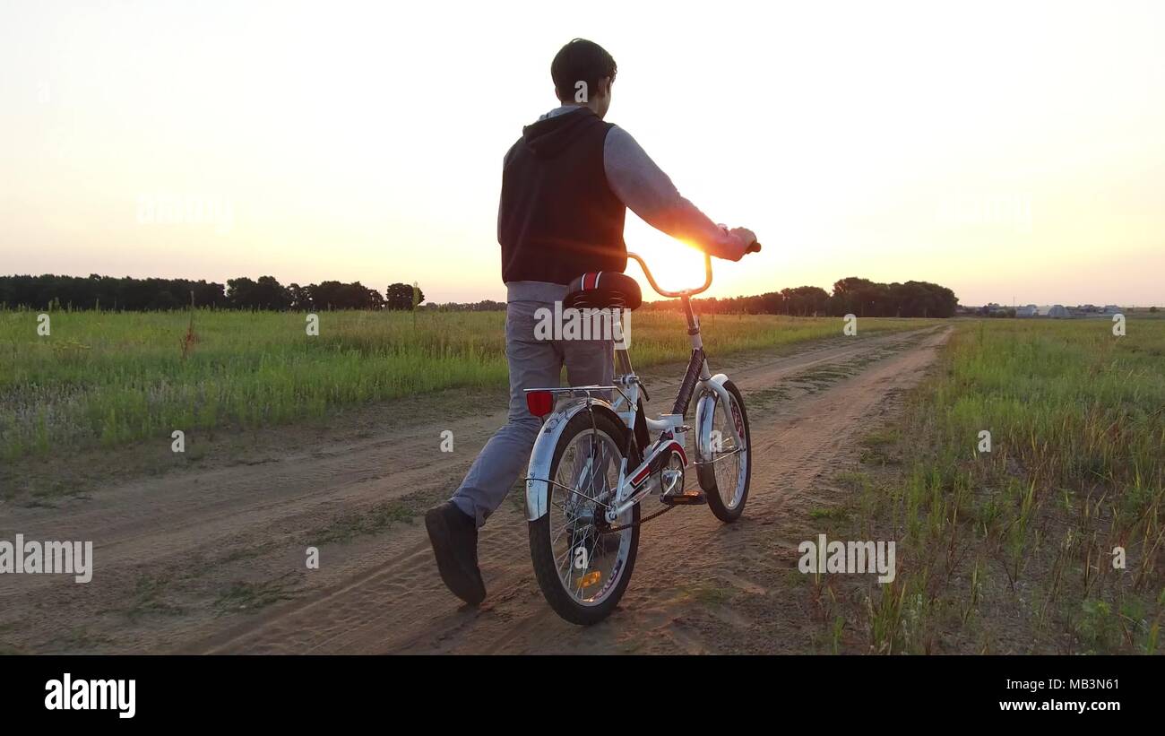 Boy teenager riding a bicycle. Boy teenager riding bicycle goes nature ...