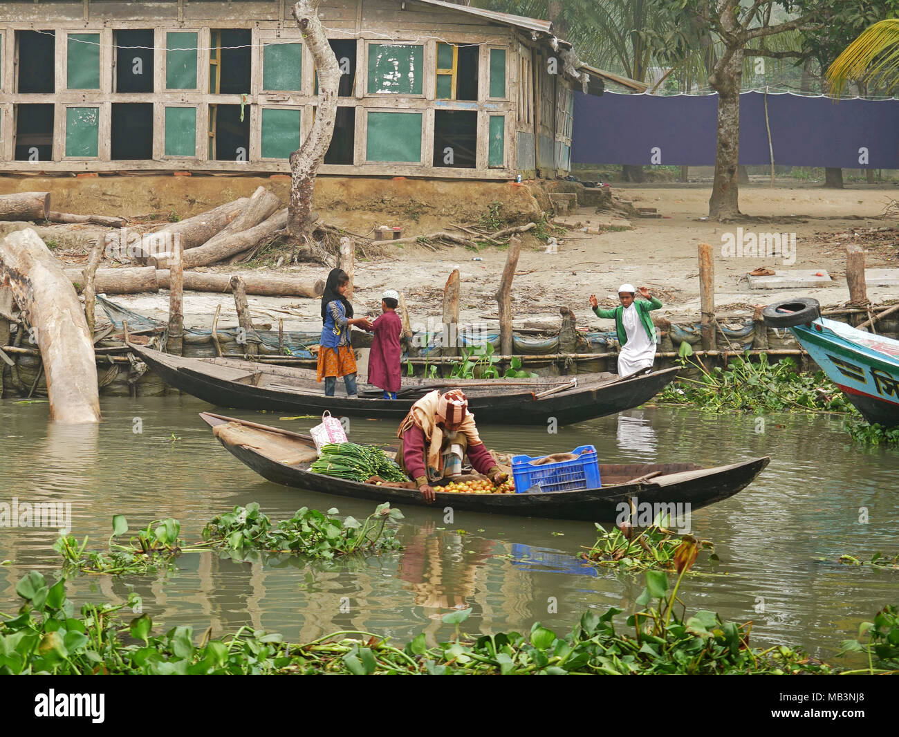 Village people seen on their boat. In the delta of rivers Ganga (Padma ...