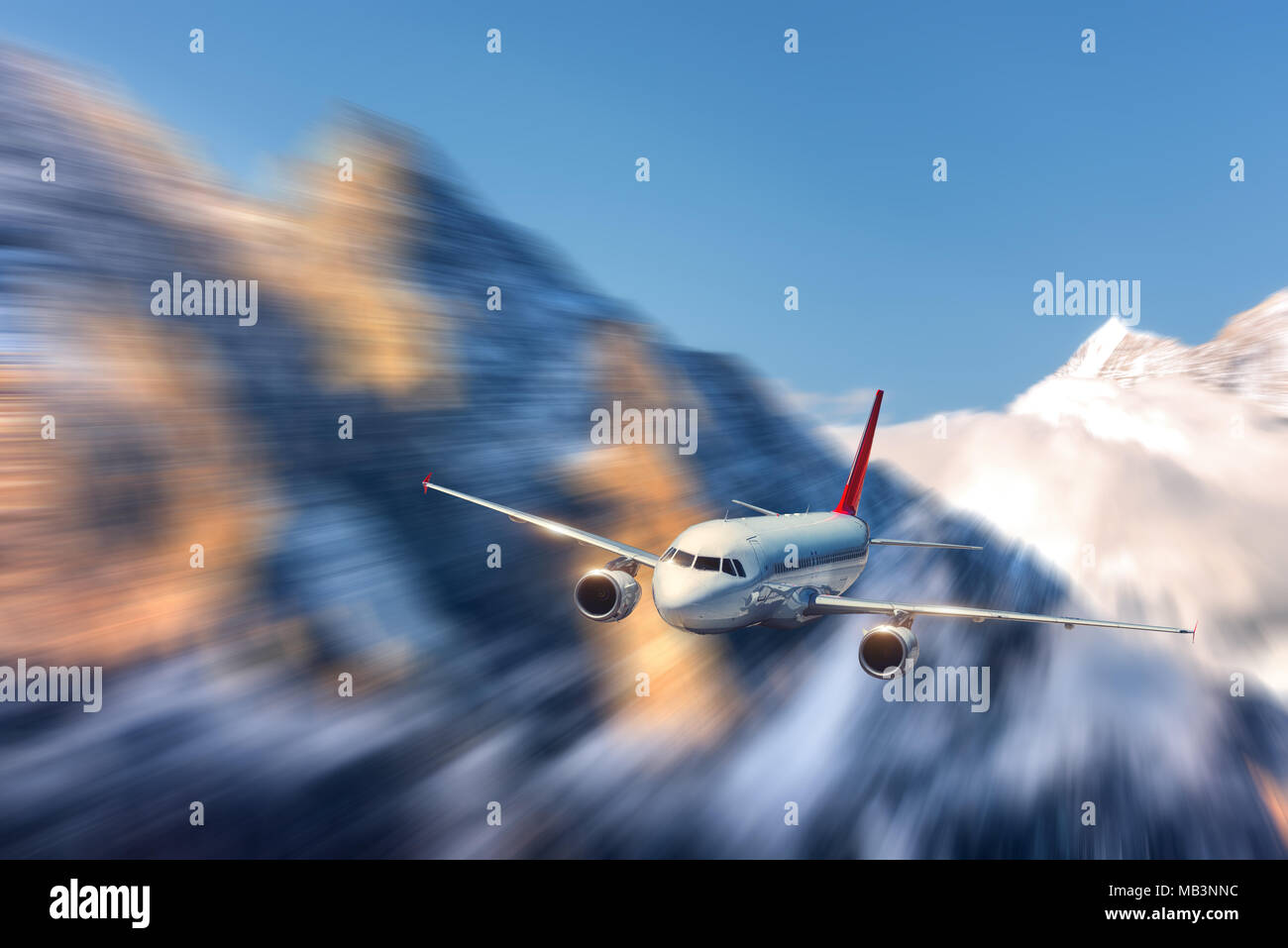 Modern airplane mith motion blur effect at sunny bright day. Landscape ...