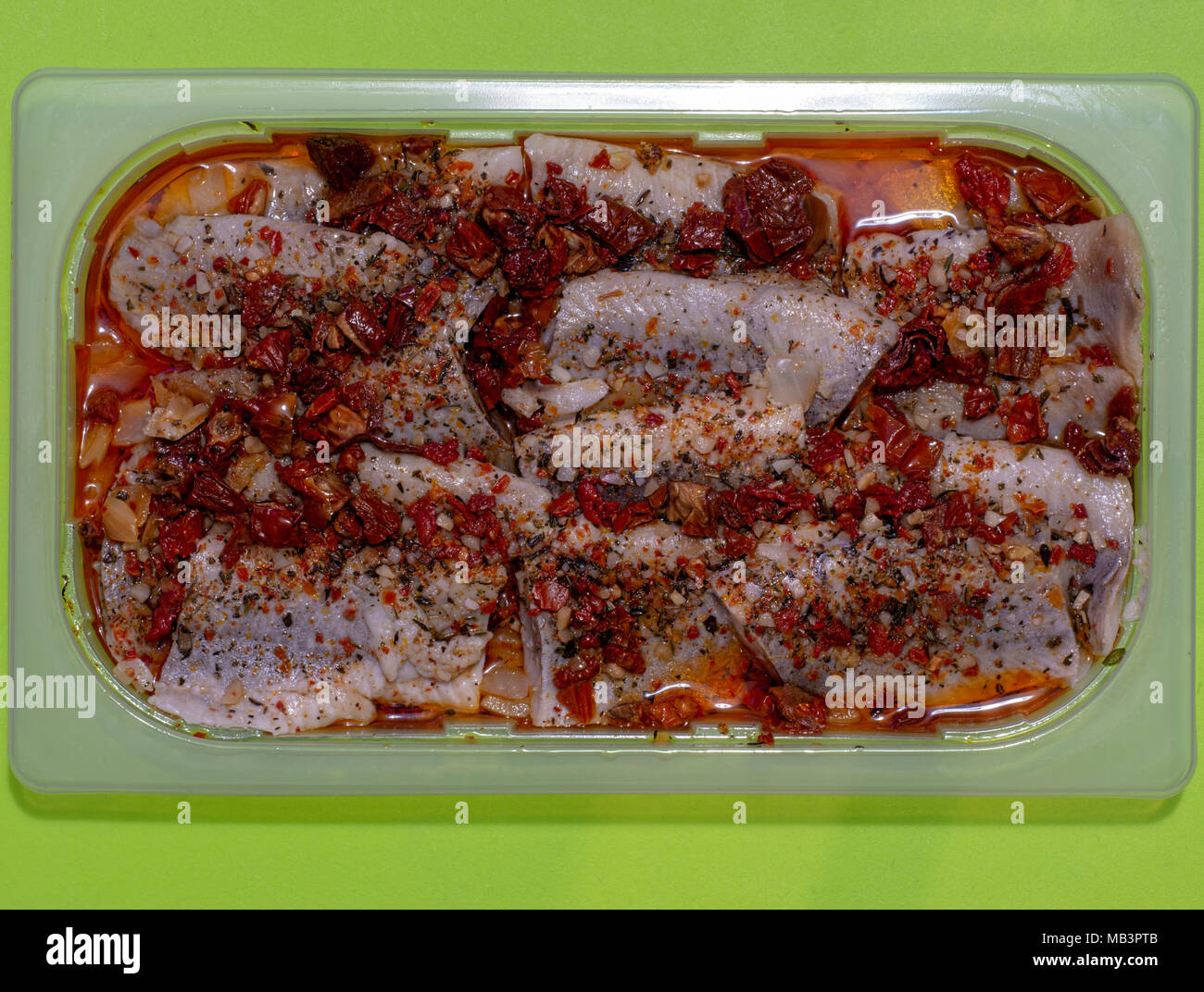 Raw fish with onion and dry tomato in olive oil. Ready to eating Stock ...