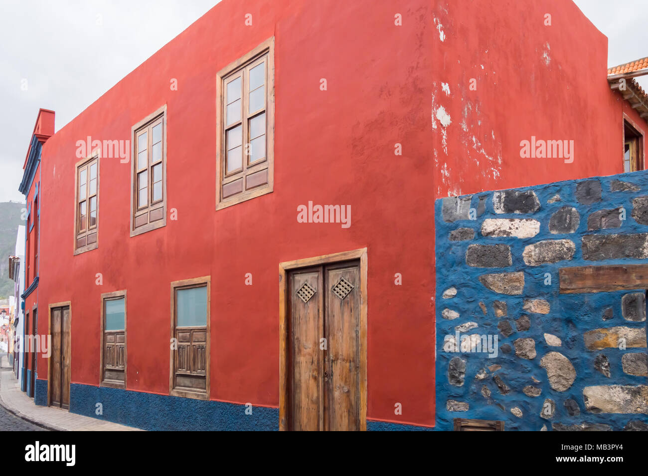 A house with red facade of Canarian architecture on the island of ...