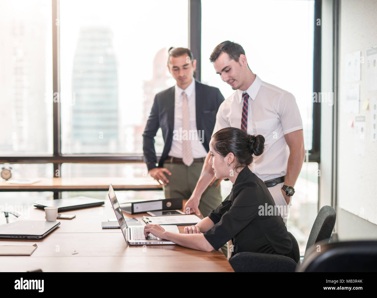 Image of business partners advice present discussing documents and ...