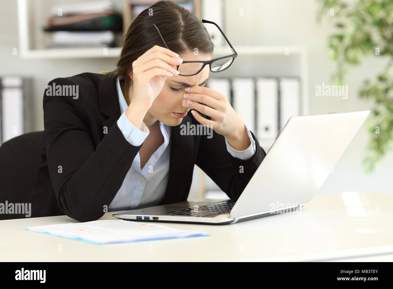 Office worker complaining suffering eyestrain at work Stock Photo - Alamy