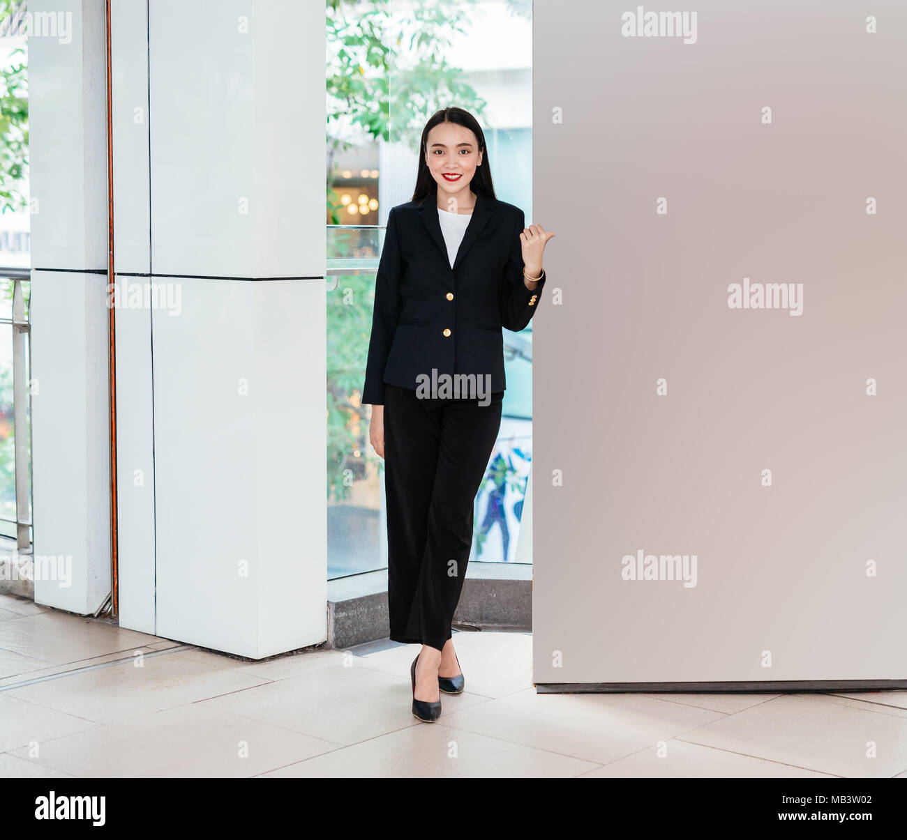 Business woman pointing to blank board the billboard Stock Photo - Alamy