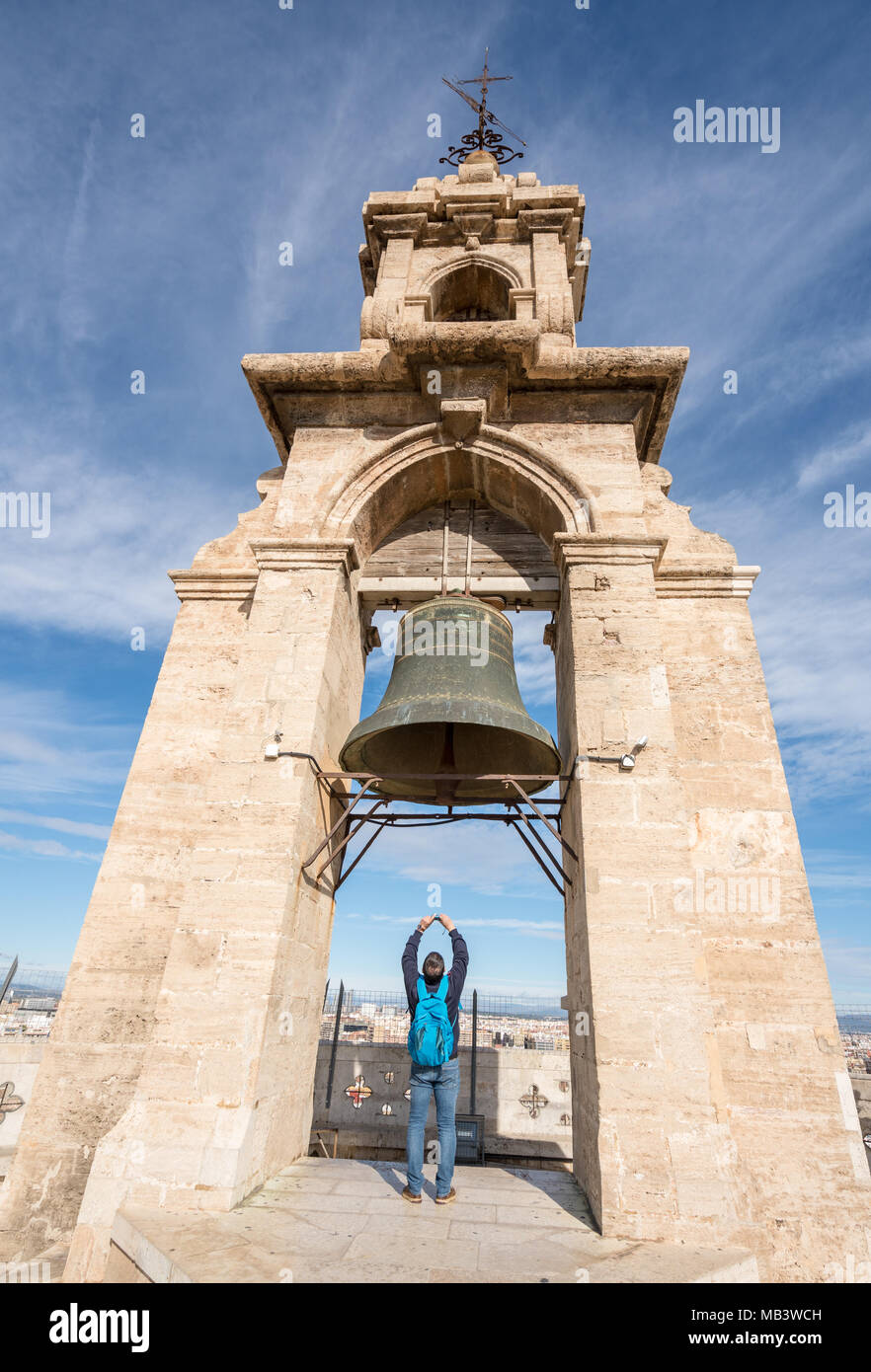 Tourist photographs bell on top of cathedral tower Stock Photo - Alamy