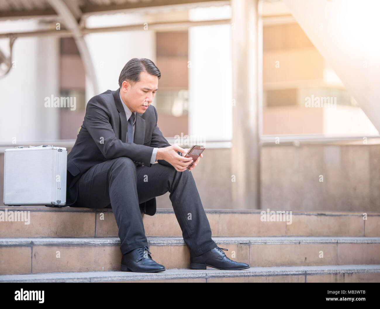 Concentrated businessman using mobile hi-res stock photography and ...