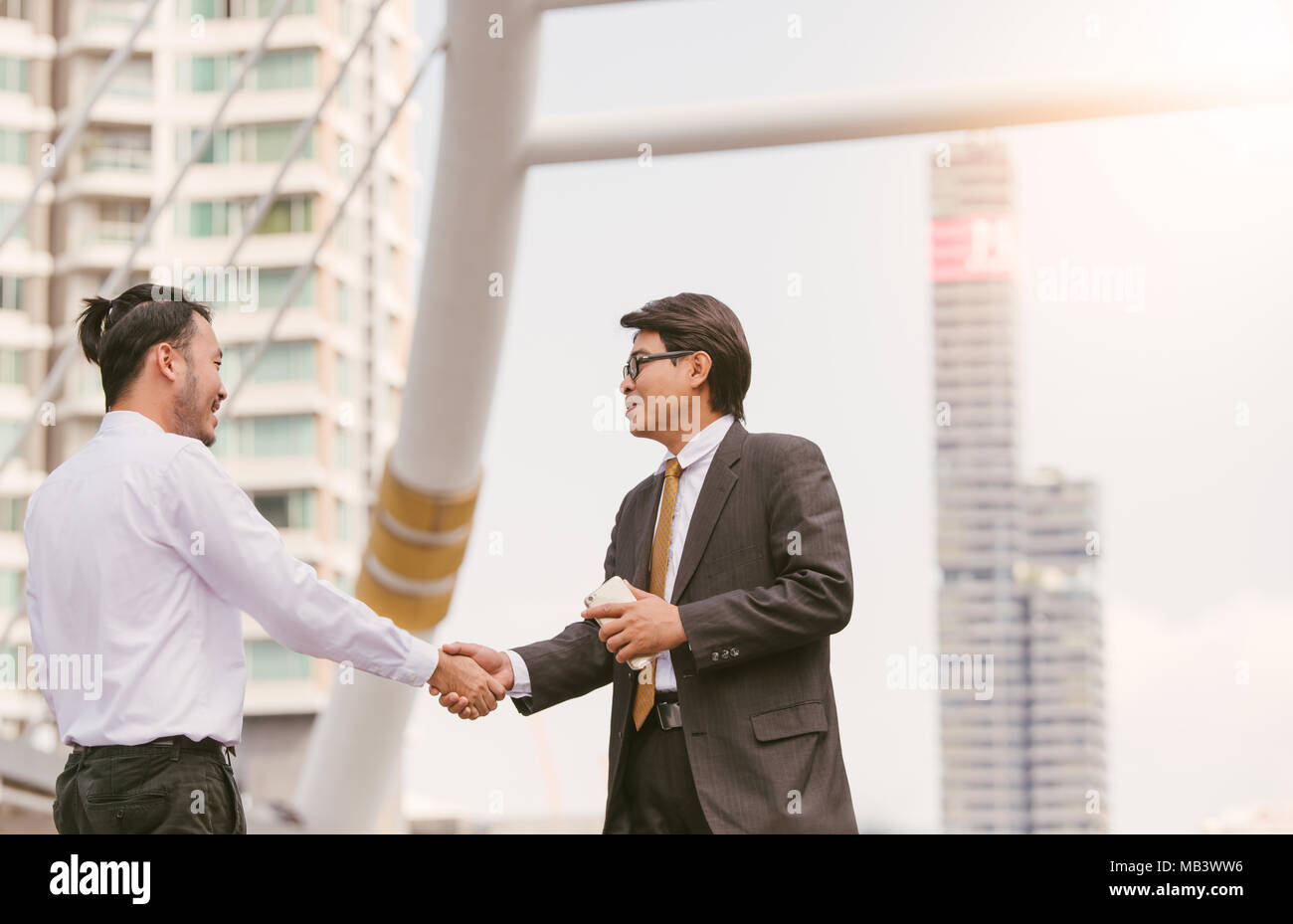 Business handshake. Handshake of two business men closing a deal city ...