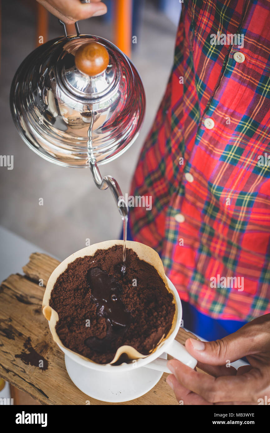 Hand drip coffee , Barista pouring water on coffee ground with filter ...