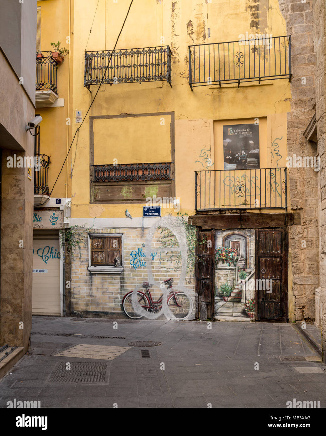 Painted mural ruined by graffiti in Valencia Stock Photo - Alamy