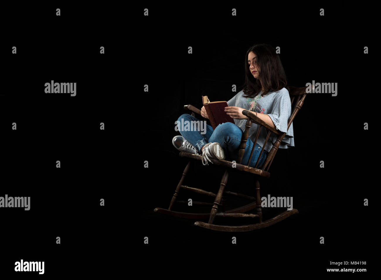 Teen girl reading book chair hi-res stock photography and images - Alamy
