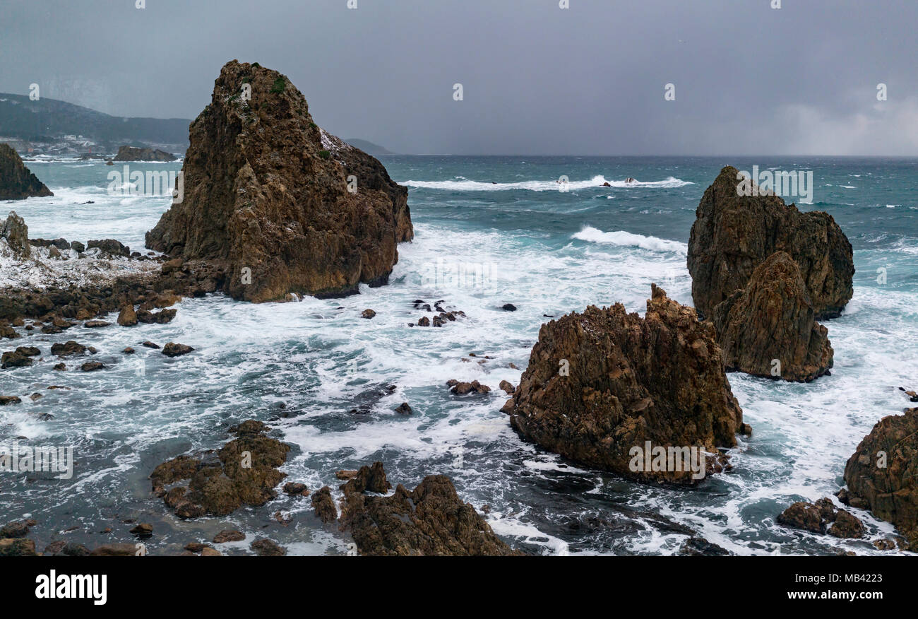 The rocky Sea of Japan coast in seen from a train on the Gono Line in ...