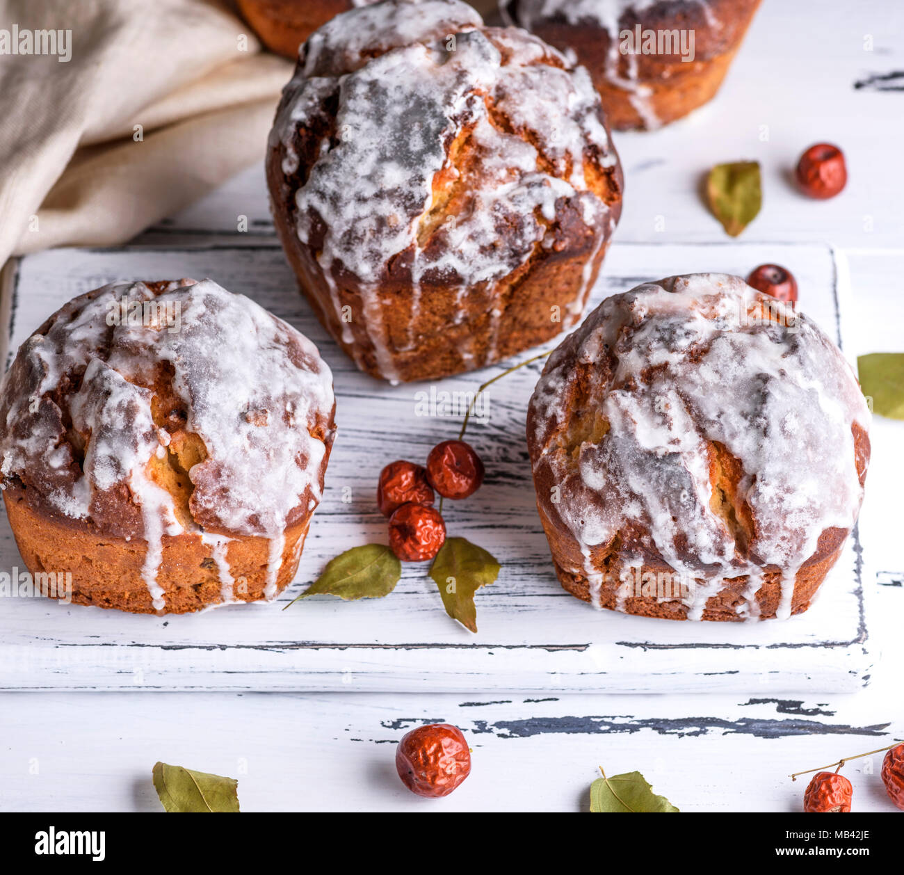 baked Easter cake with white lemon glaze on a white wooden board, top ...