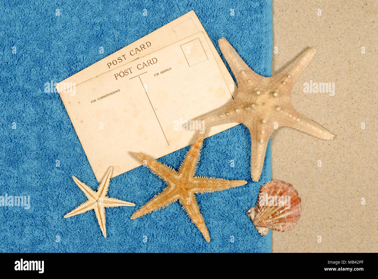 Seashore background with postcards shells beach towel and starfish ...
