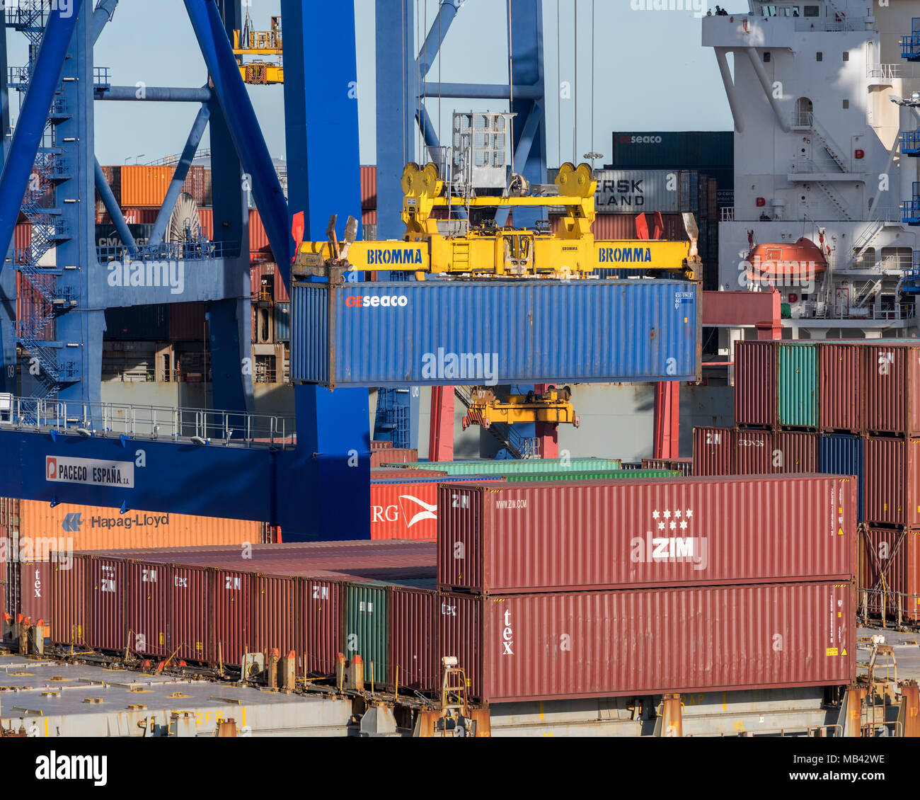 Containers being loaded onto ship in Valencia Stock Photo - Alamy
