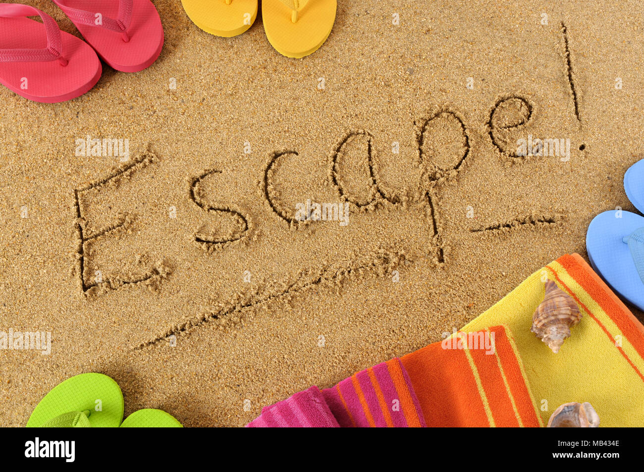 Beach background with towel, flip flops and the word Escape written in ...