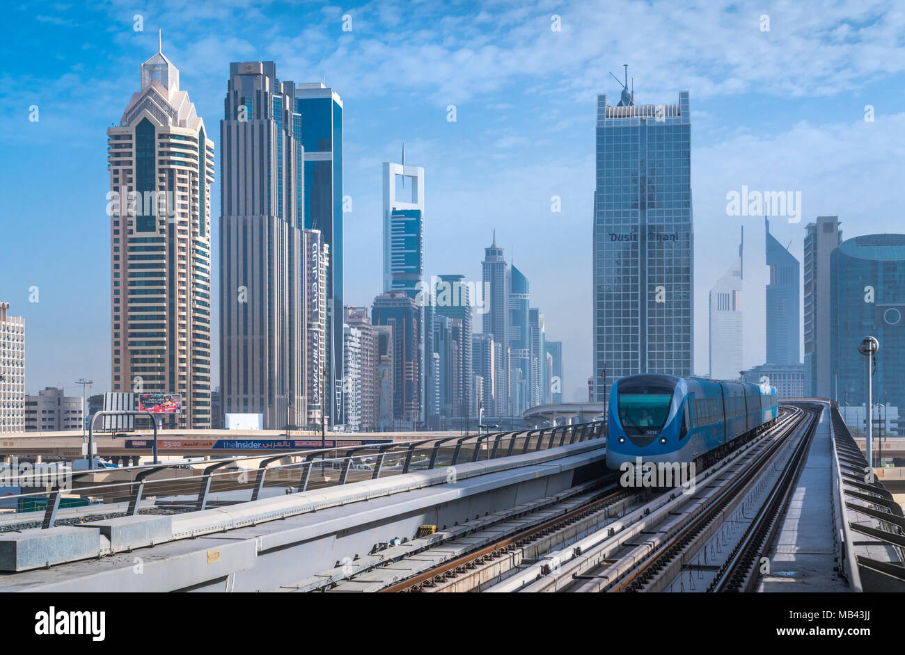 Tall buildings and the Metro train track in downtown Dubai, UAE, Middle ...