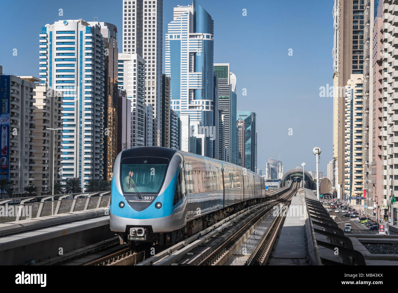 A Dubai Metro train and downtown office towers in Dujbai, UAE, Middle ...