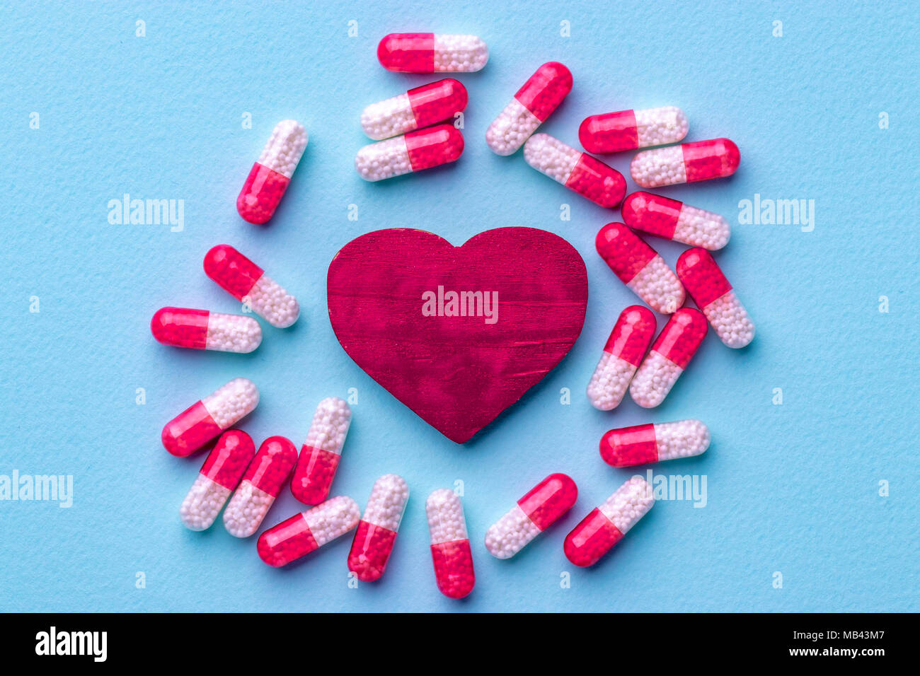Pharmaceutical medicine red capsules with red heart on blue Horizontal ...