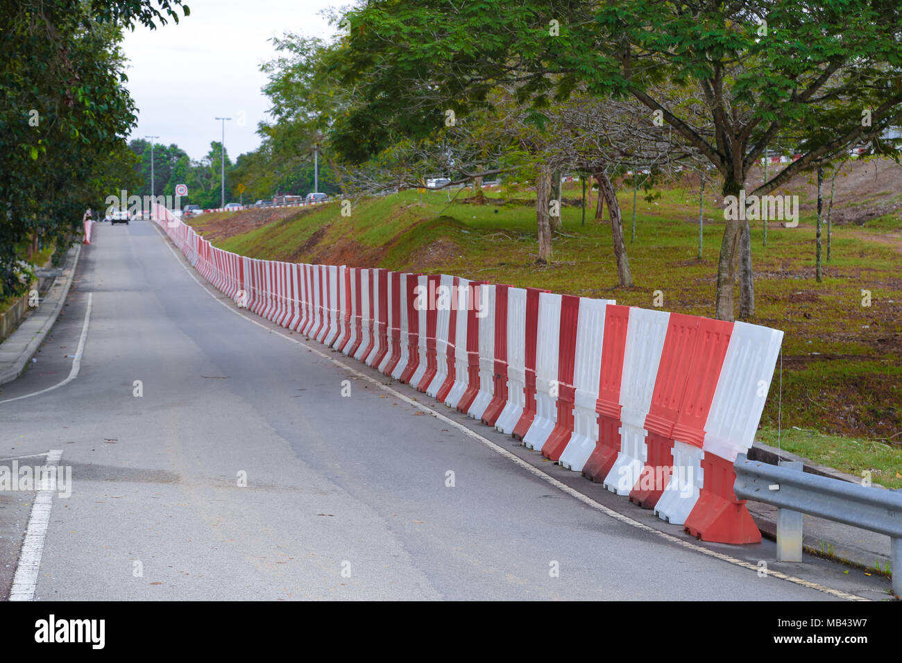 Road barriers erected along the work in progress construction area ...