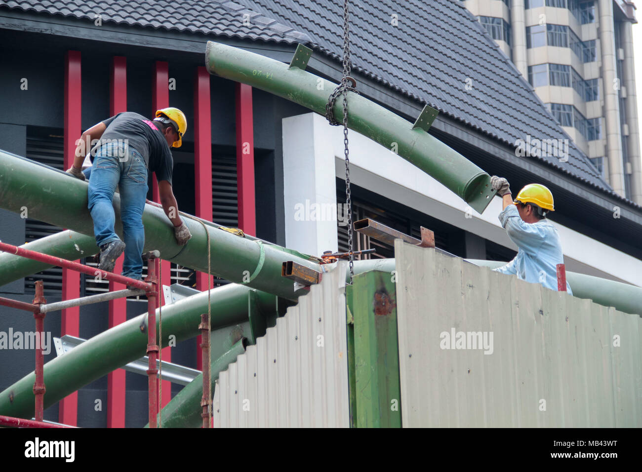 Construction workers building a metal structure Stock Photo - Alamy