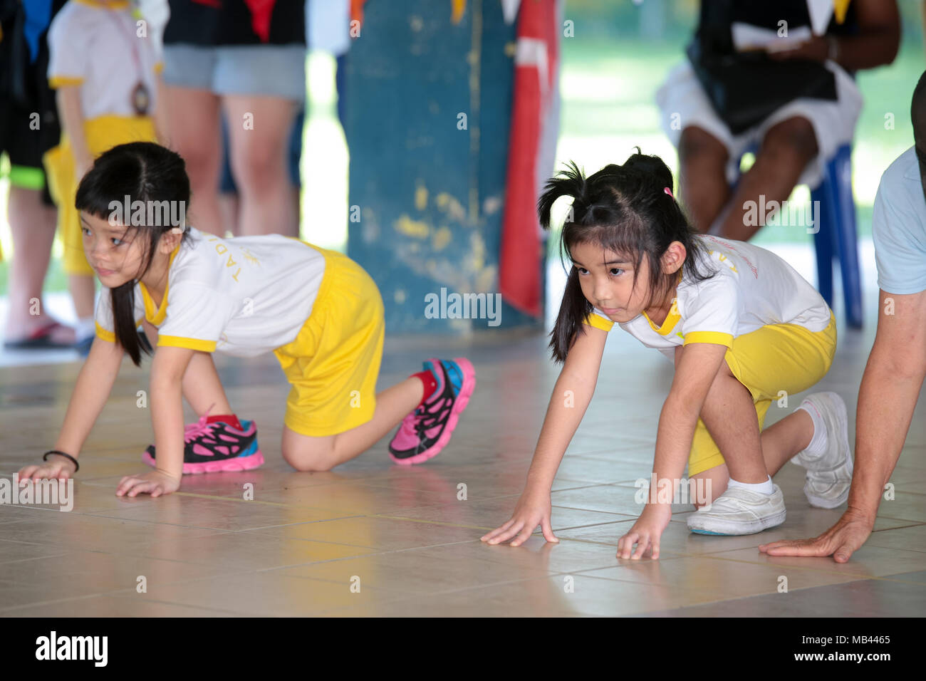 2 children ready to sprint forward at their Kindergarten sport day ...
