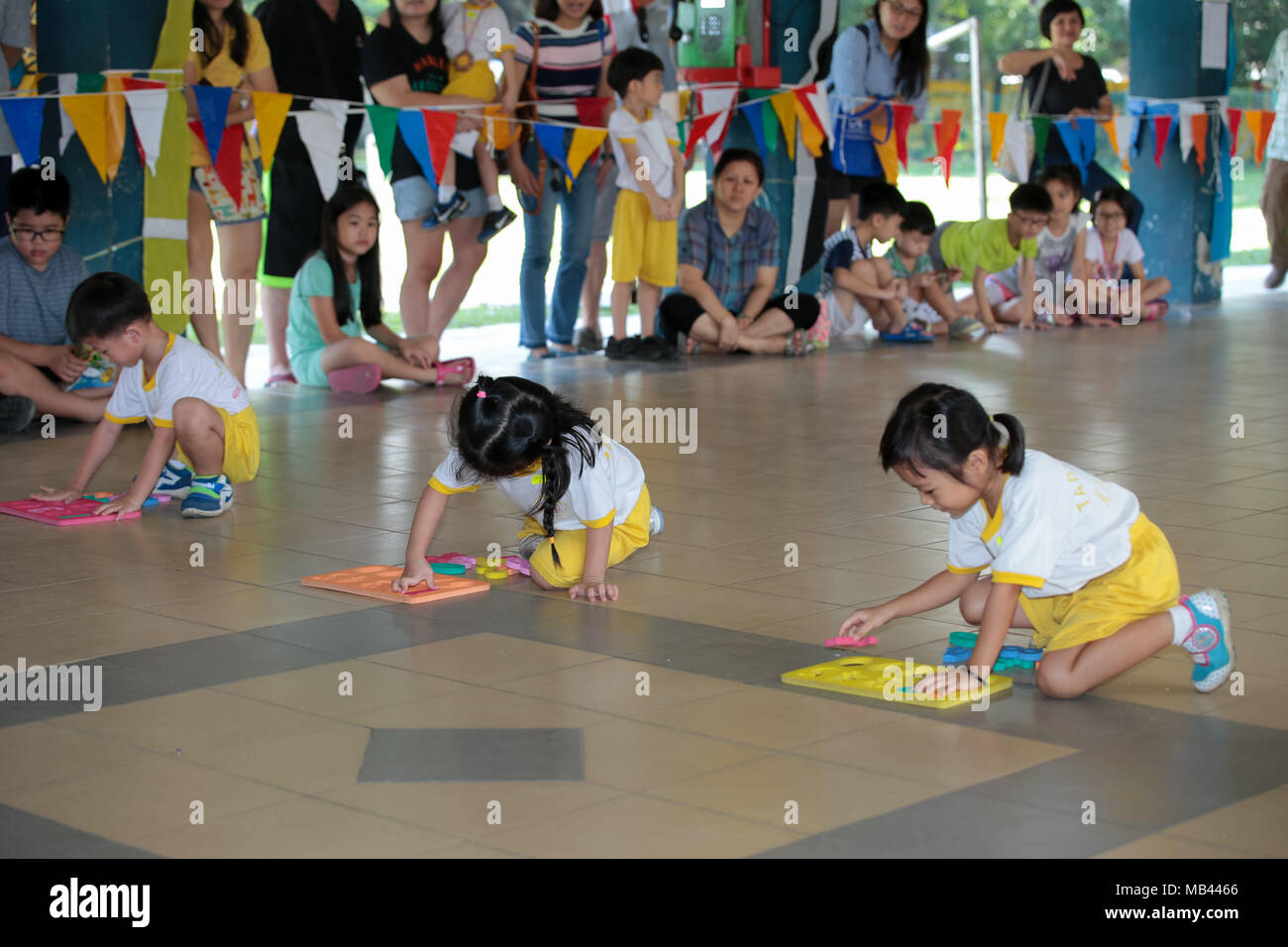 Children are competing to finish the puzzle block during their ...