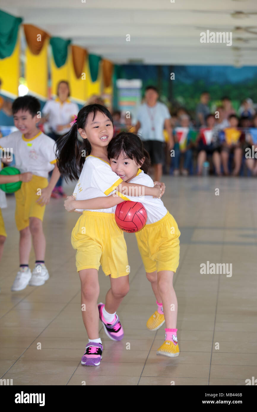 Children are playing hug the ball teamwork game during their ...