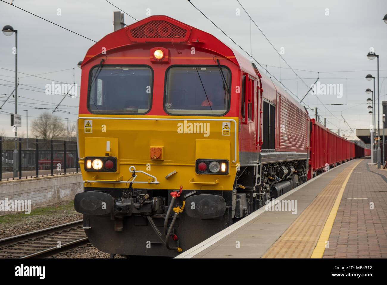 A long red train heads north cargo and destination unknown Stock Photo ...